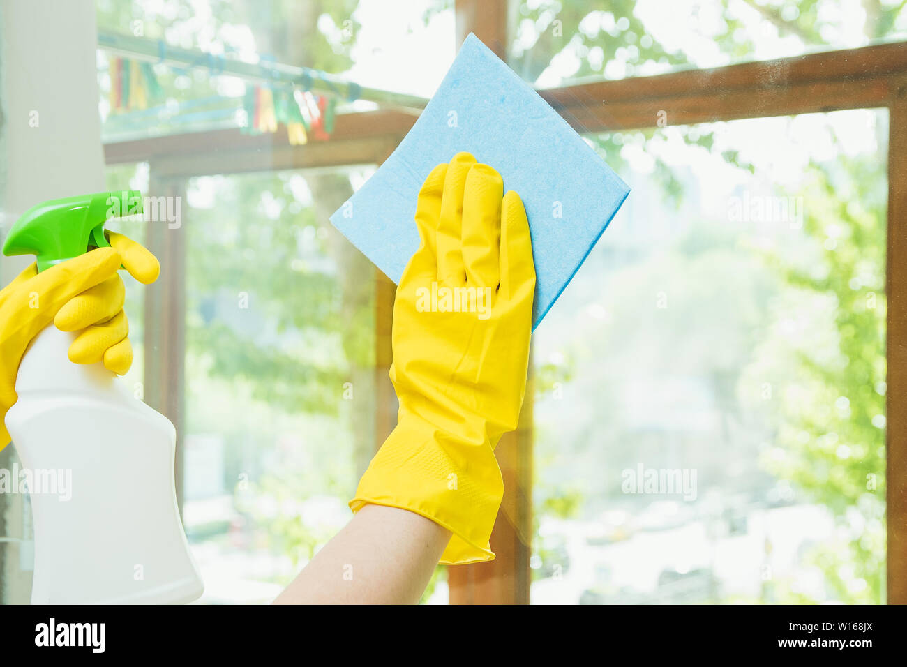 A cleaning company cleans the window of dirt. Housewife in yellow ...