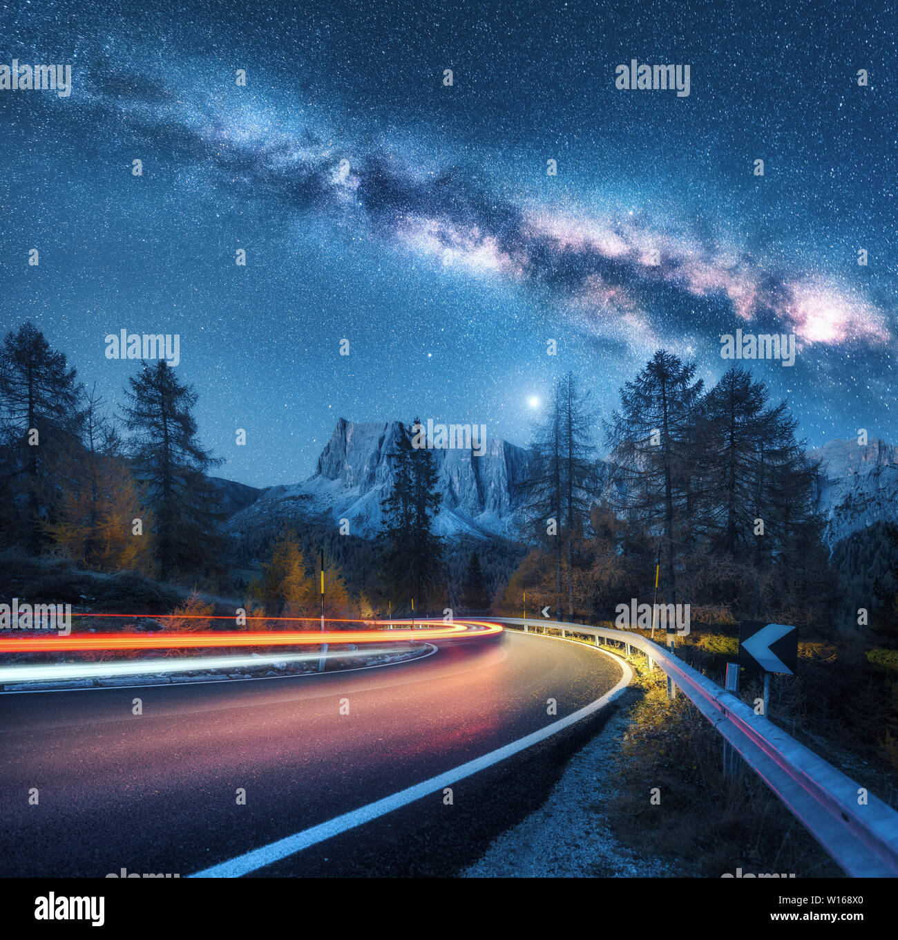 Milky Way over mountain road. Blurred car headlights Stock Photo - Alamy