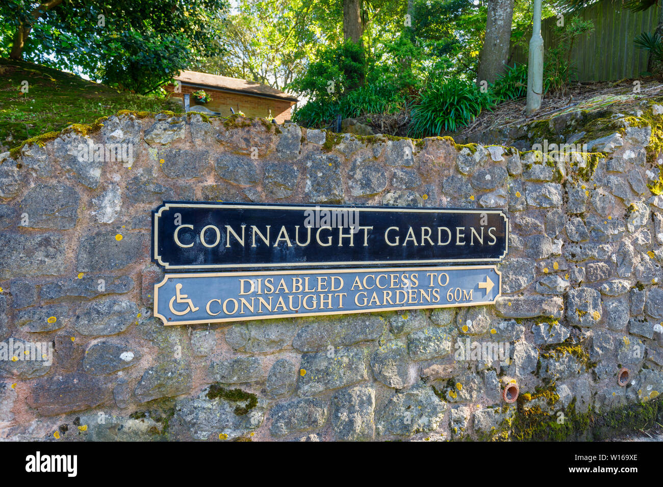 Name sign on a wall at the entrance of Connaught Gardens, Sidmouth, a ...