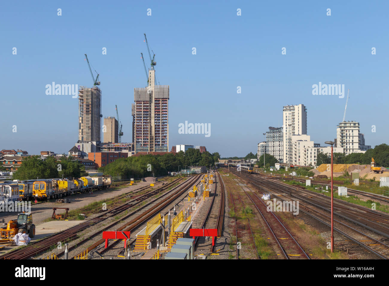 The changing skyine of Woking, Surrey: railway tracks lead into tower ...