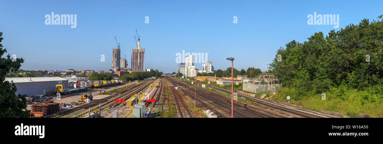 The changing skyine of Woking, Surrey: railway tracks lead into tower ...