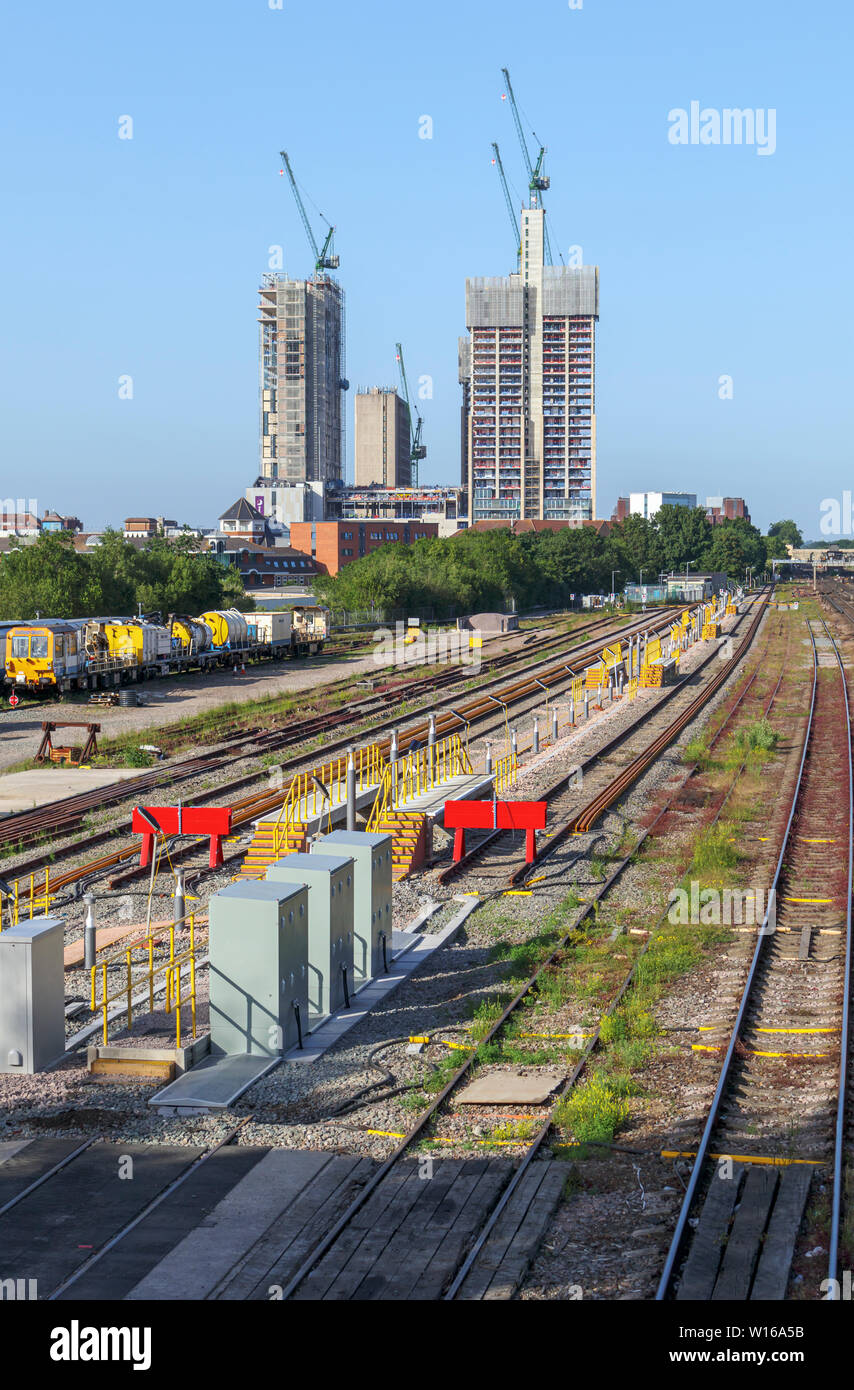 The changing skyine of Woking, Surrey: railway tracks lead into tower ...
