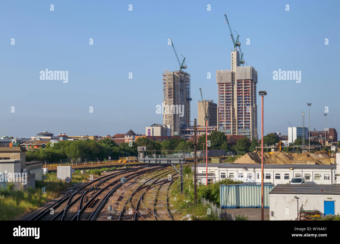 The changing skyine of Woking, Surrey: railway tracks lead into tower ...