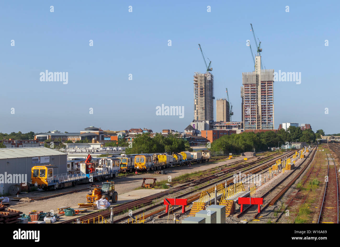 The changing skyine of Woking, Surrey: railway tracks lead into tower ...