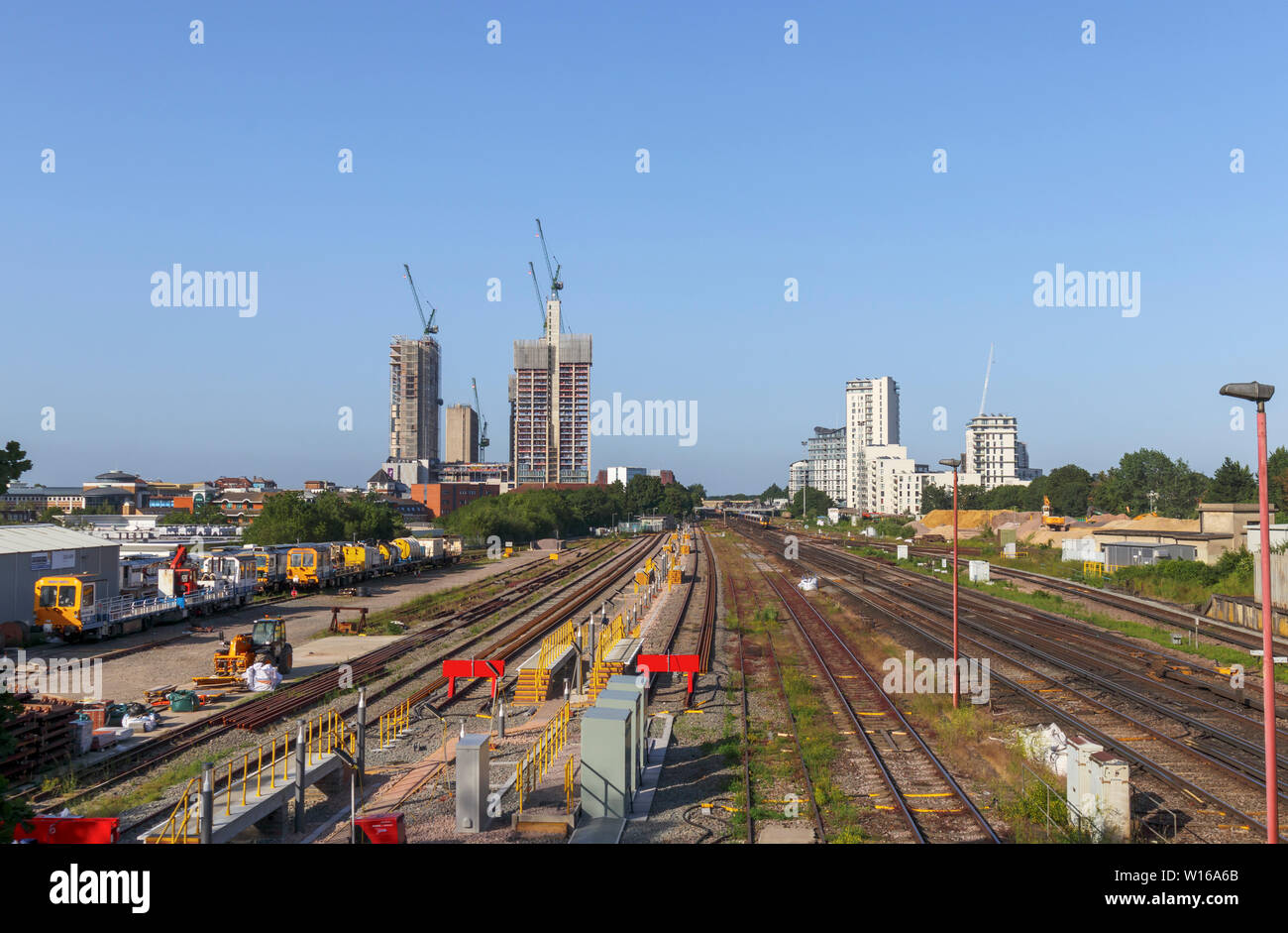The changing skyine of Woking, Surrey: railway tracks lead into tower ...
