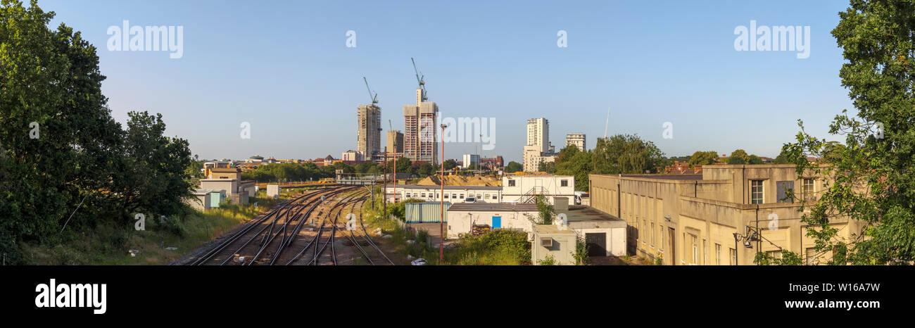 The changing skyine of Woking, Surrey: railway tracks lead into tower ...