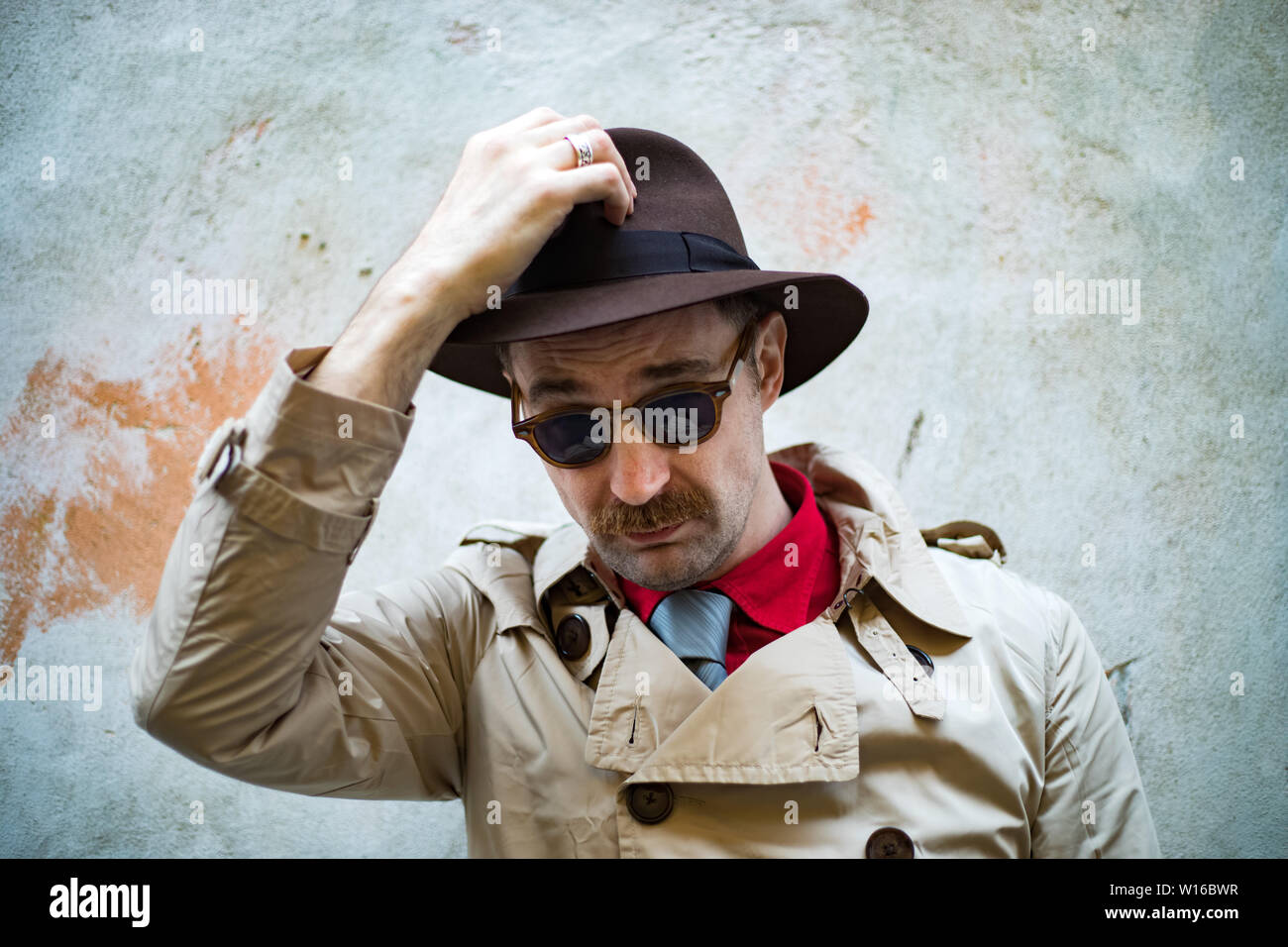 Detective walking in the city slums Stock Photo - Alamy