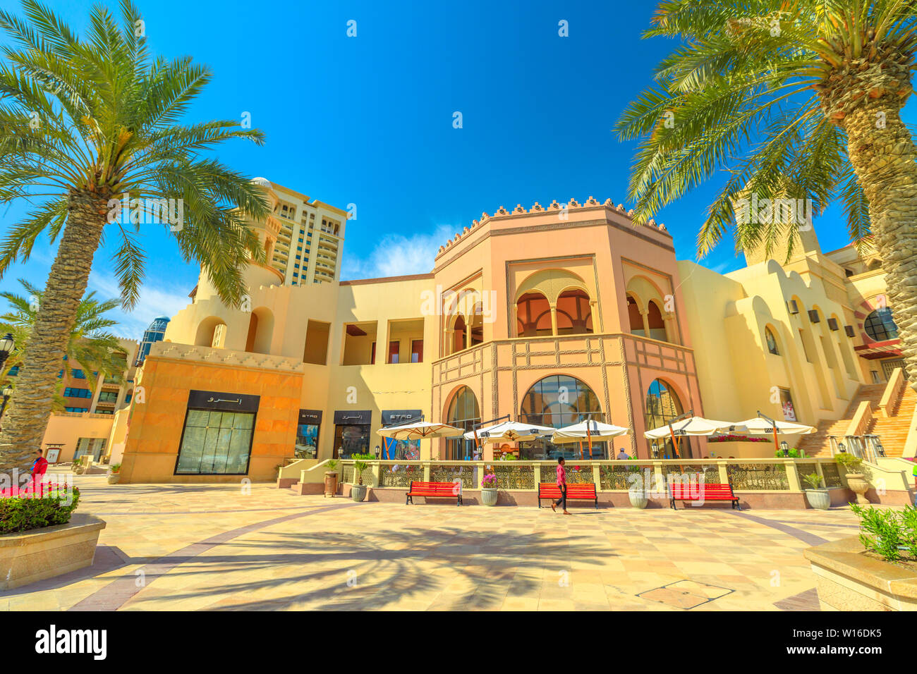 Doha, Qatar - February 18, 2019:Benches and palm trees along marina ...