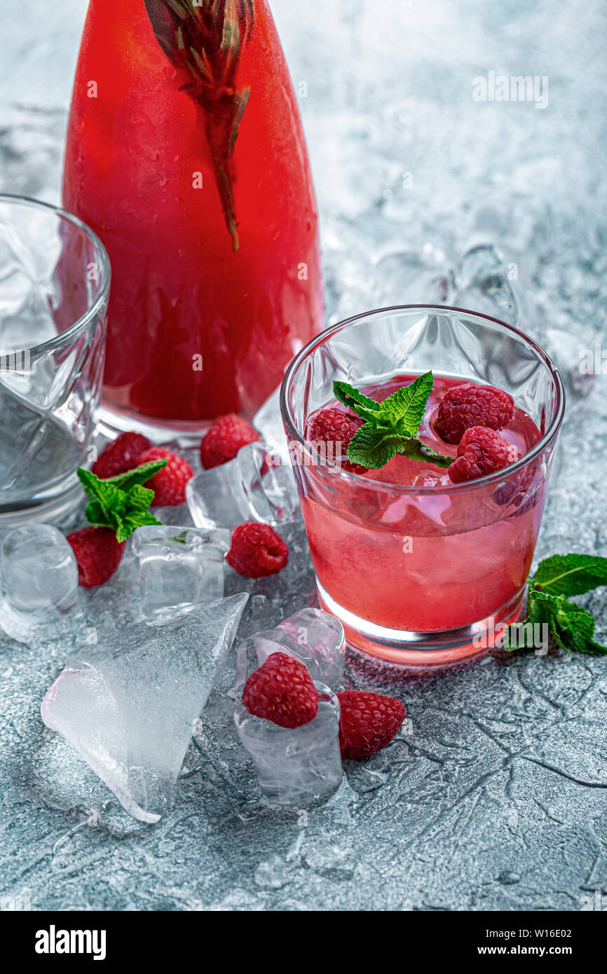 Raspberry cocktail, fizz, lemonade, ice tea with fresh mint on blue ...