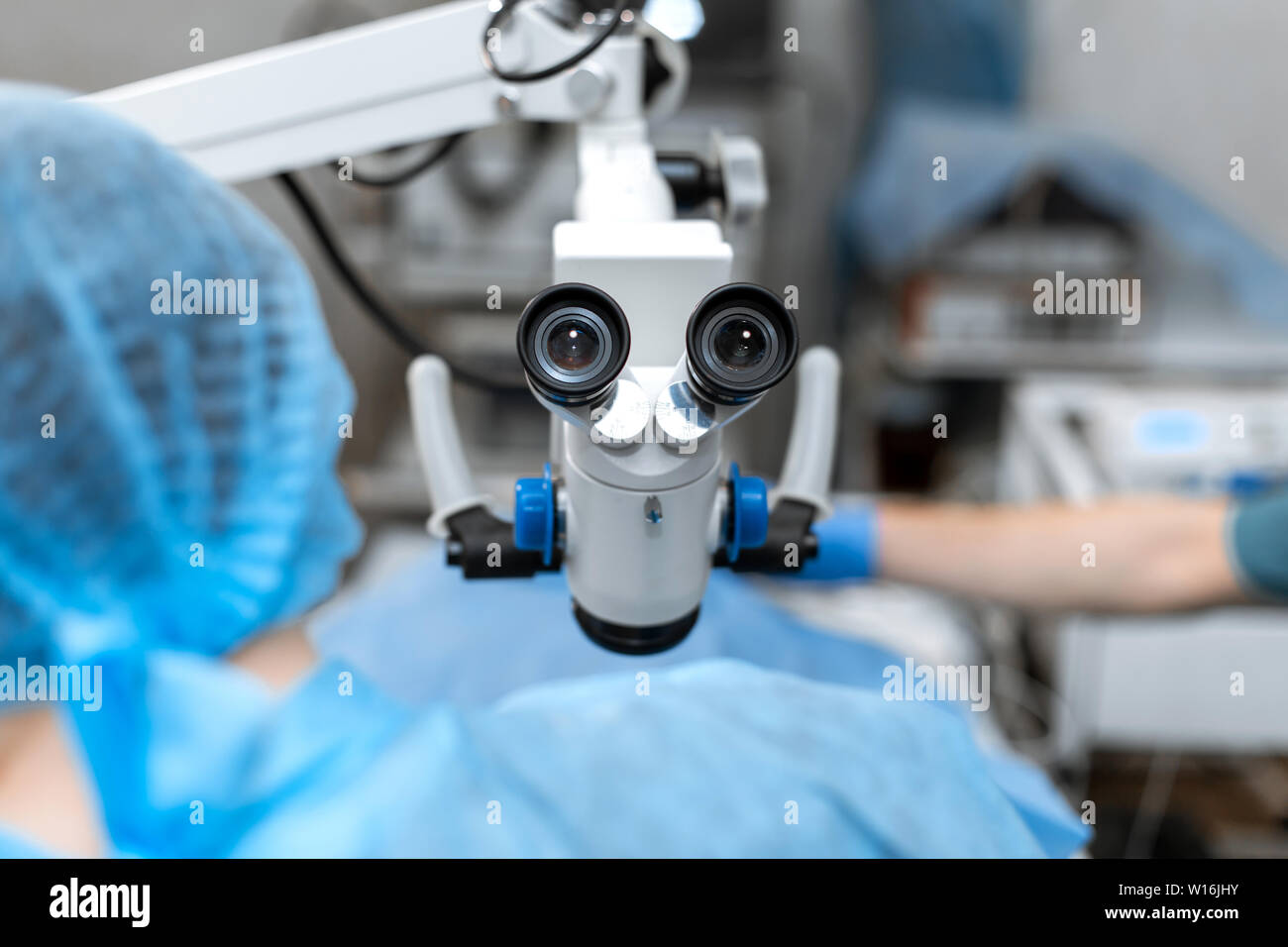 Vet ophthalmologist surgical microscope in operating room. and dog with ...