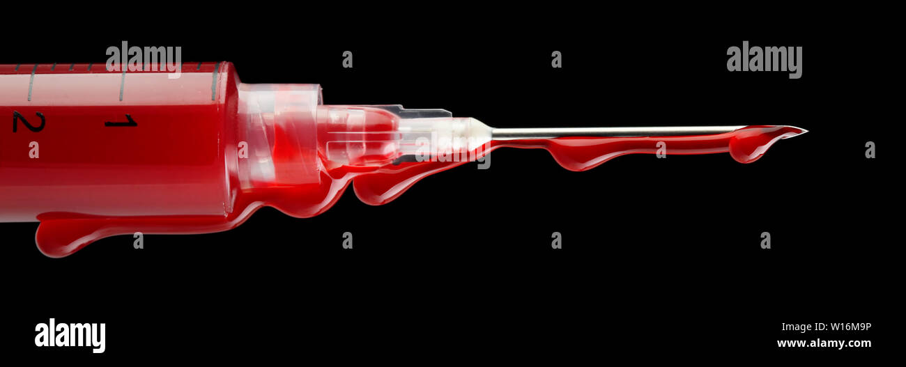Syringe filled with blood and dripping from the needle - isolated on ...