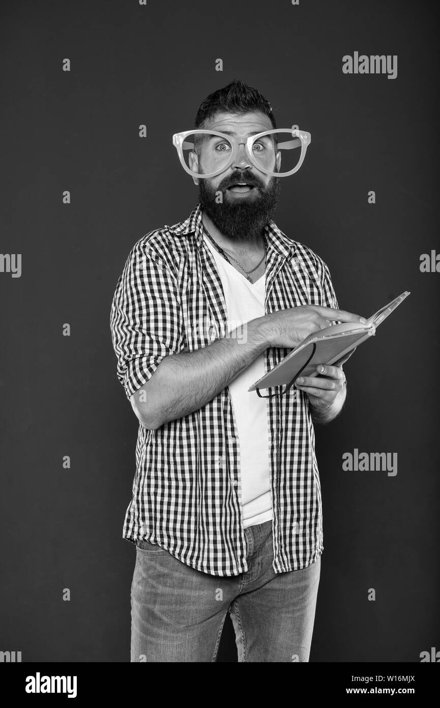 Freak and geek. Bearded man in party glasses reading book. Study nerd ...