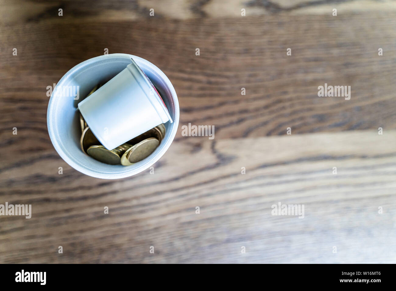 Coins in cup hi-res stock photography and images - Alamy