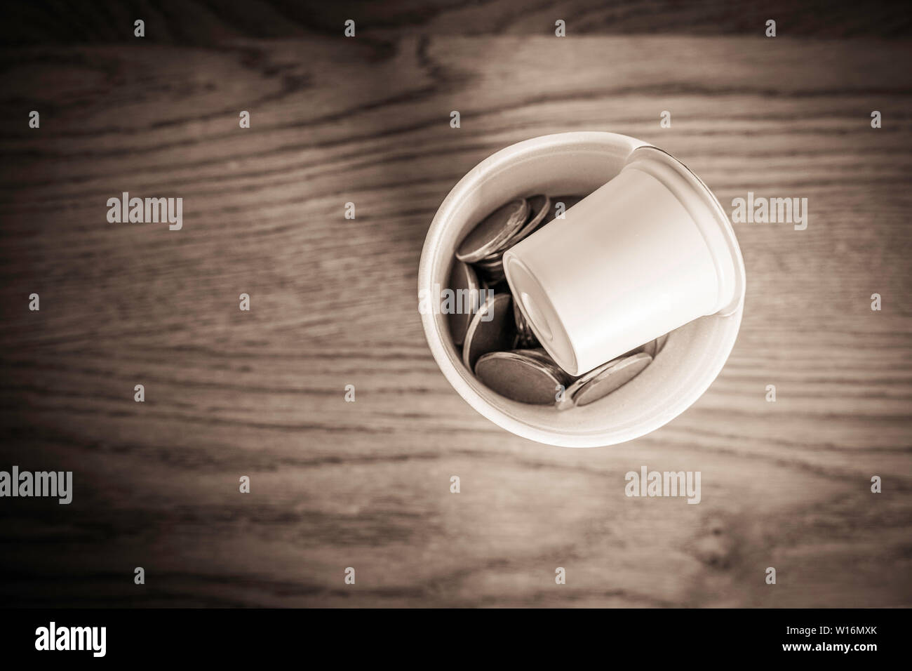 Coins in cup hi-res stock photography and images - Alamy