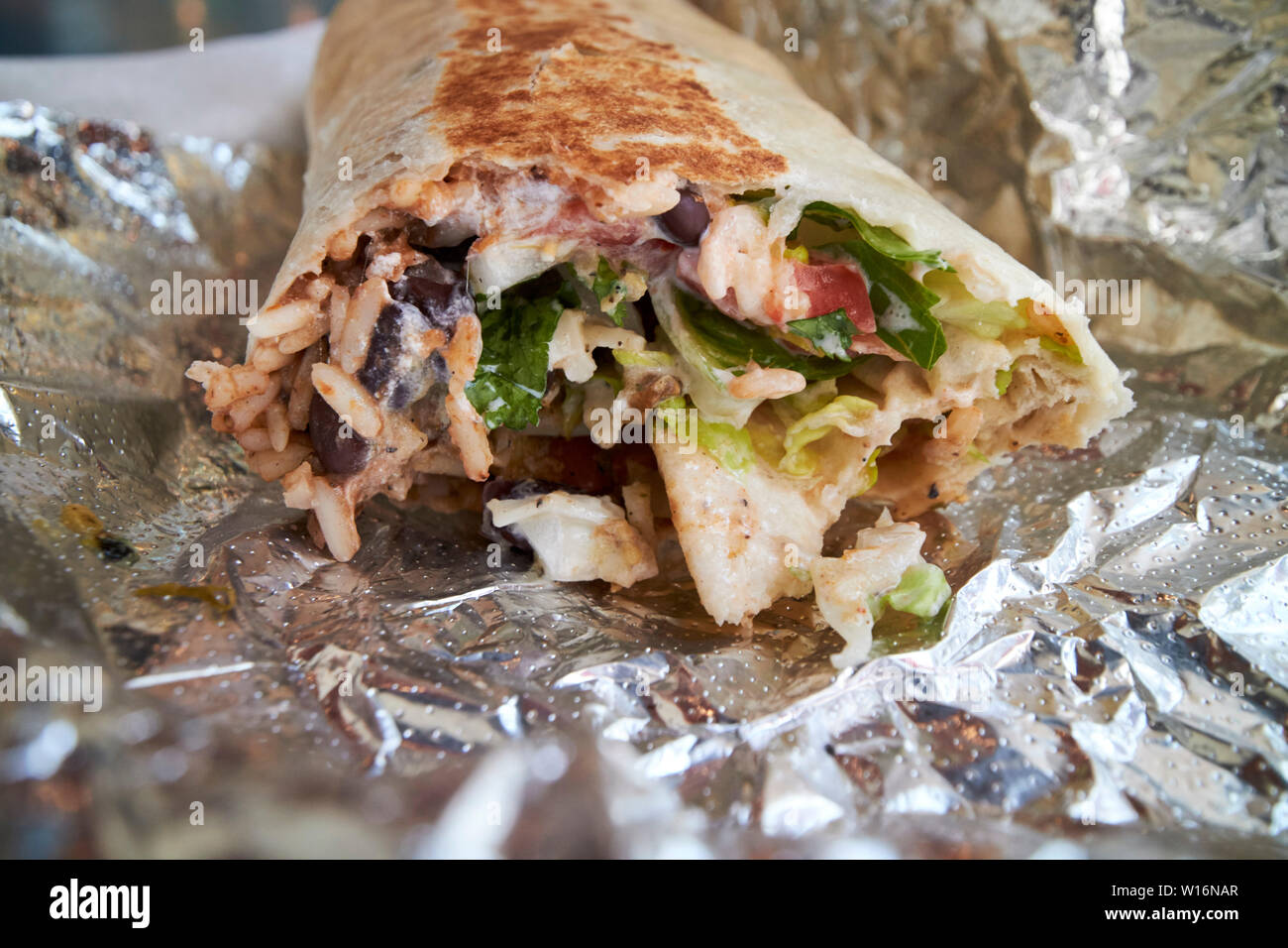 half eaten burrito in silver paper Chicago IL USA Stock Photo - Alamy
