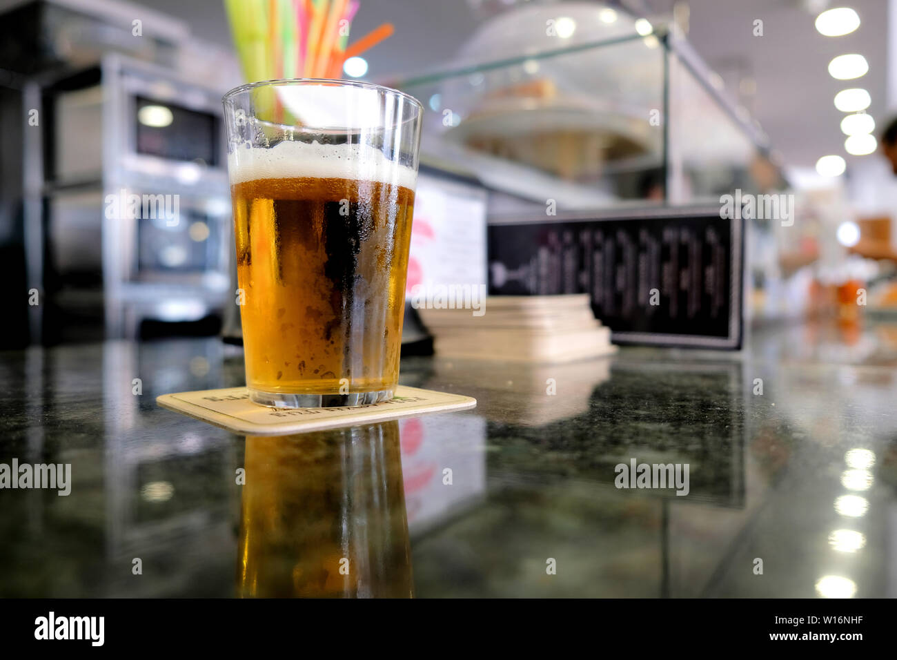 Caña or beer served in a glass on a counter in a cafe and bar in Nerja ...
