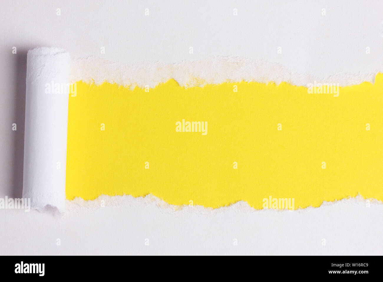 Torn paper with yellow background Stock Photo - Alamy
