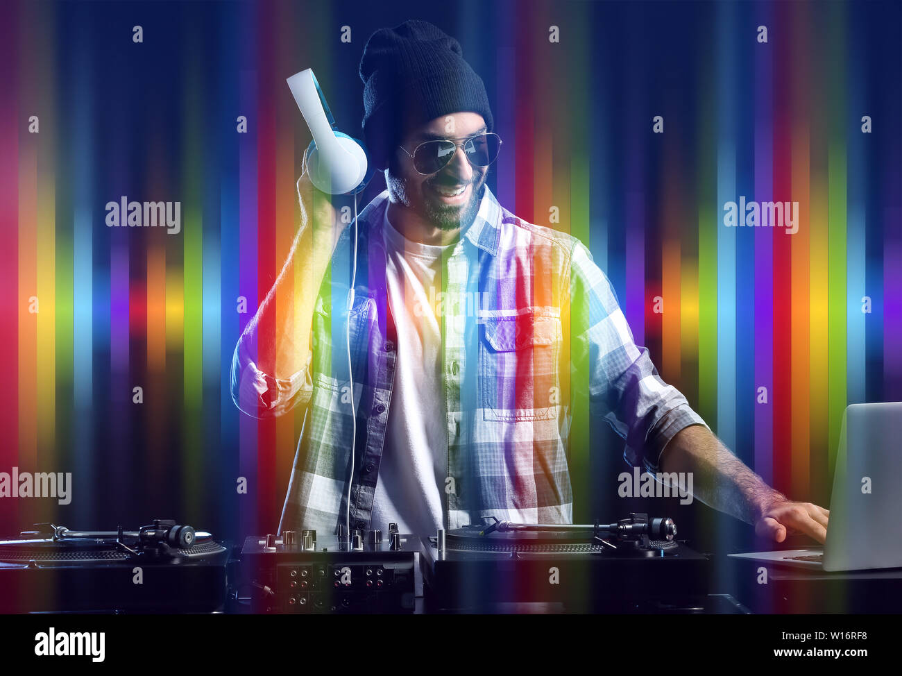 Male DJ playing music in night club Stock Photo - Alamy