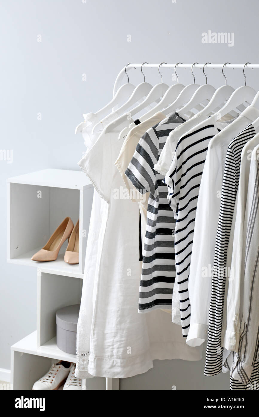 Rack with clean clothes in dressing room Stock Photo - Alamy