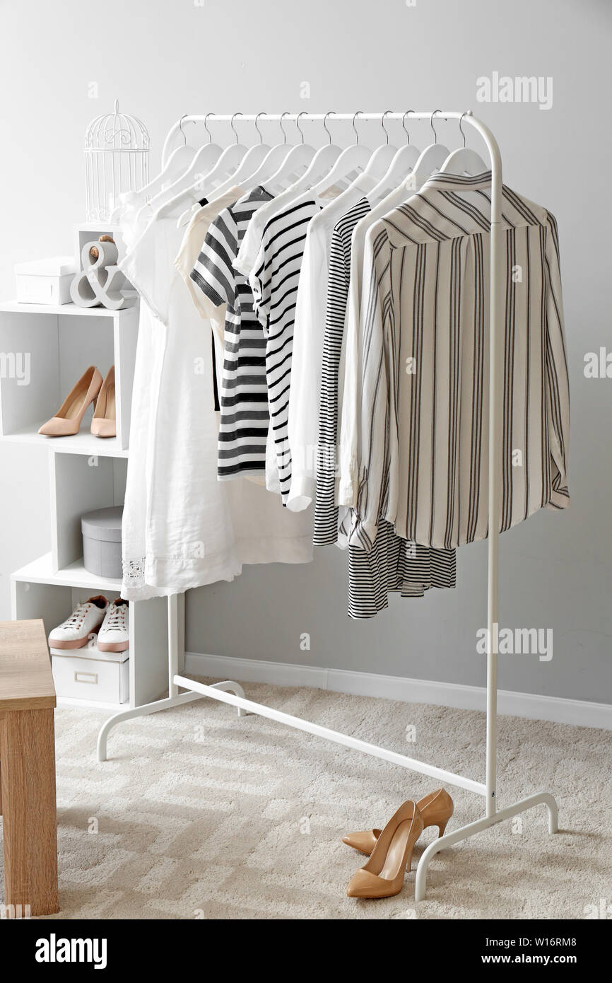 Rack with clean clothes in dressing room Stock Photo - Alamy