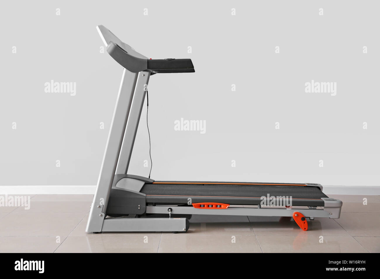 Modern treadmill near light wall Stock Photo - Alamy