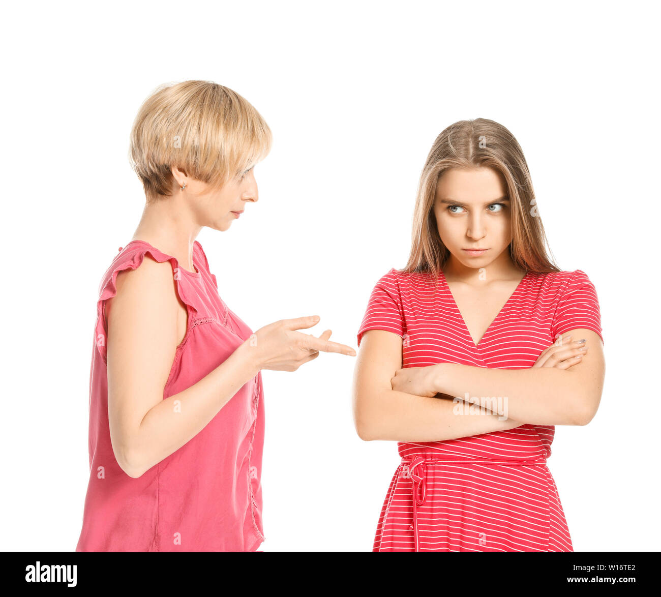 Portrait of quarreling mother and daughter on white background Stock ...