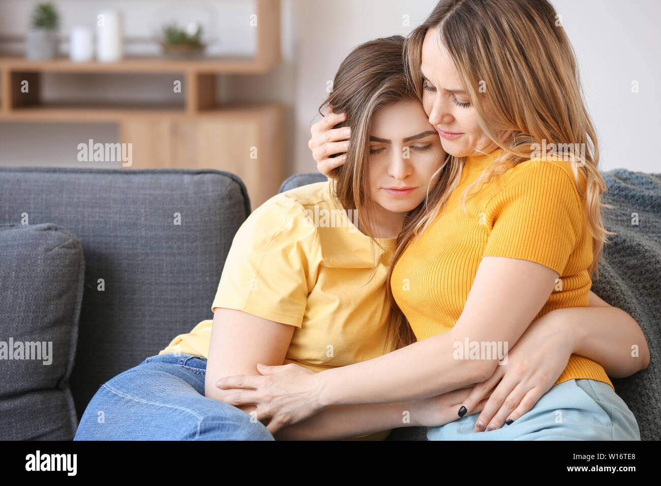 Mother calming her sad daughter at home Stock Photo - Alamy