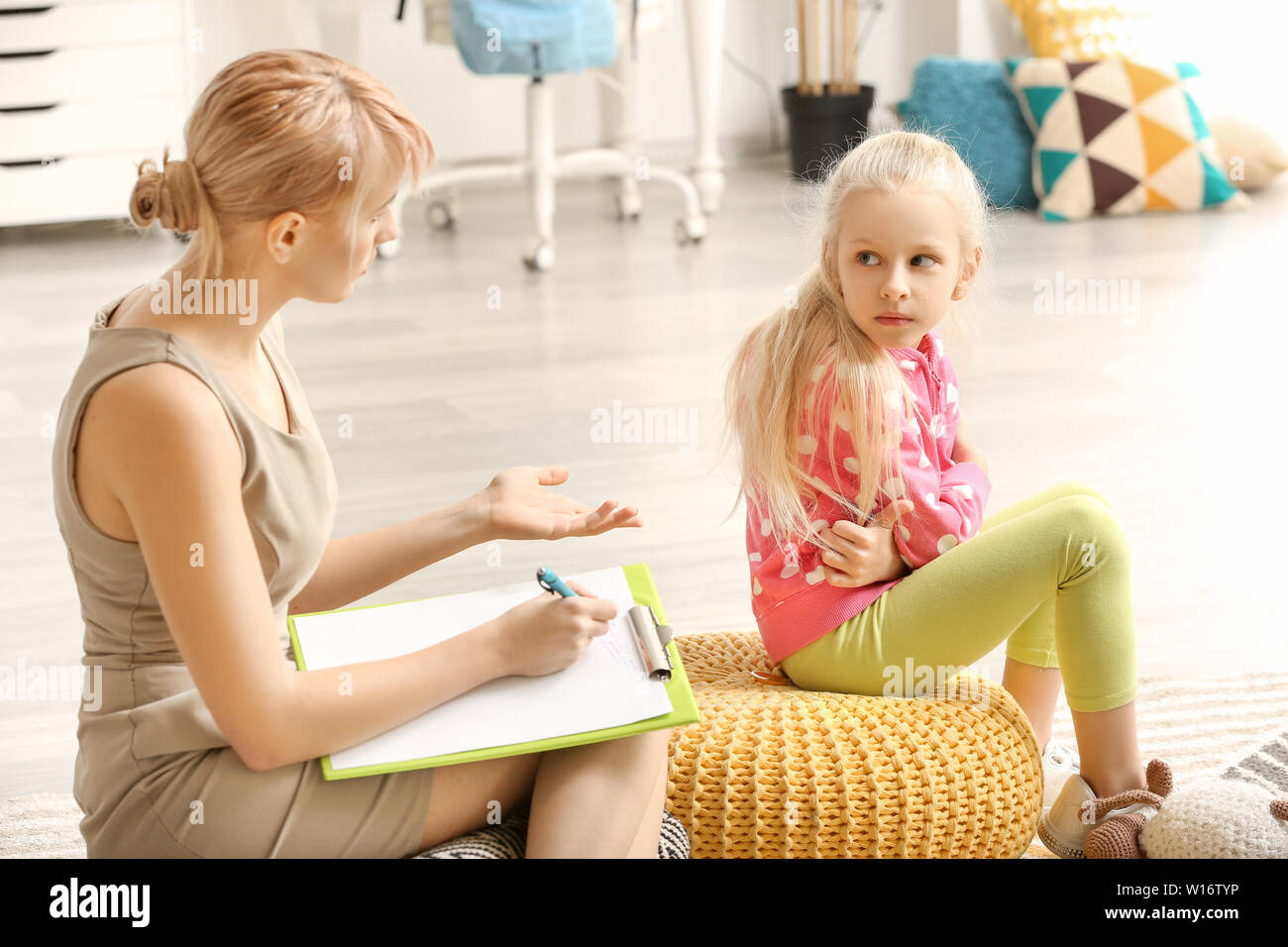 Female psychologist working with little girl in office Stock Photo - Alamy
