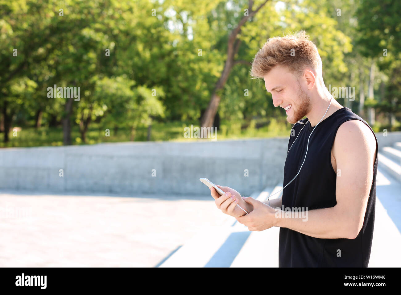 Sporty young man checking his pulse outdoors Stock Photo - Alamy
