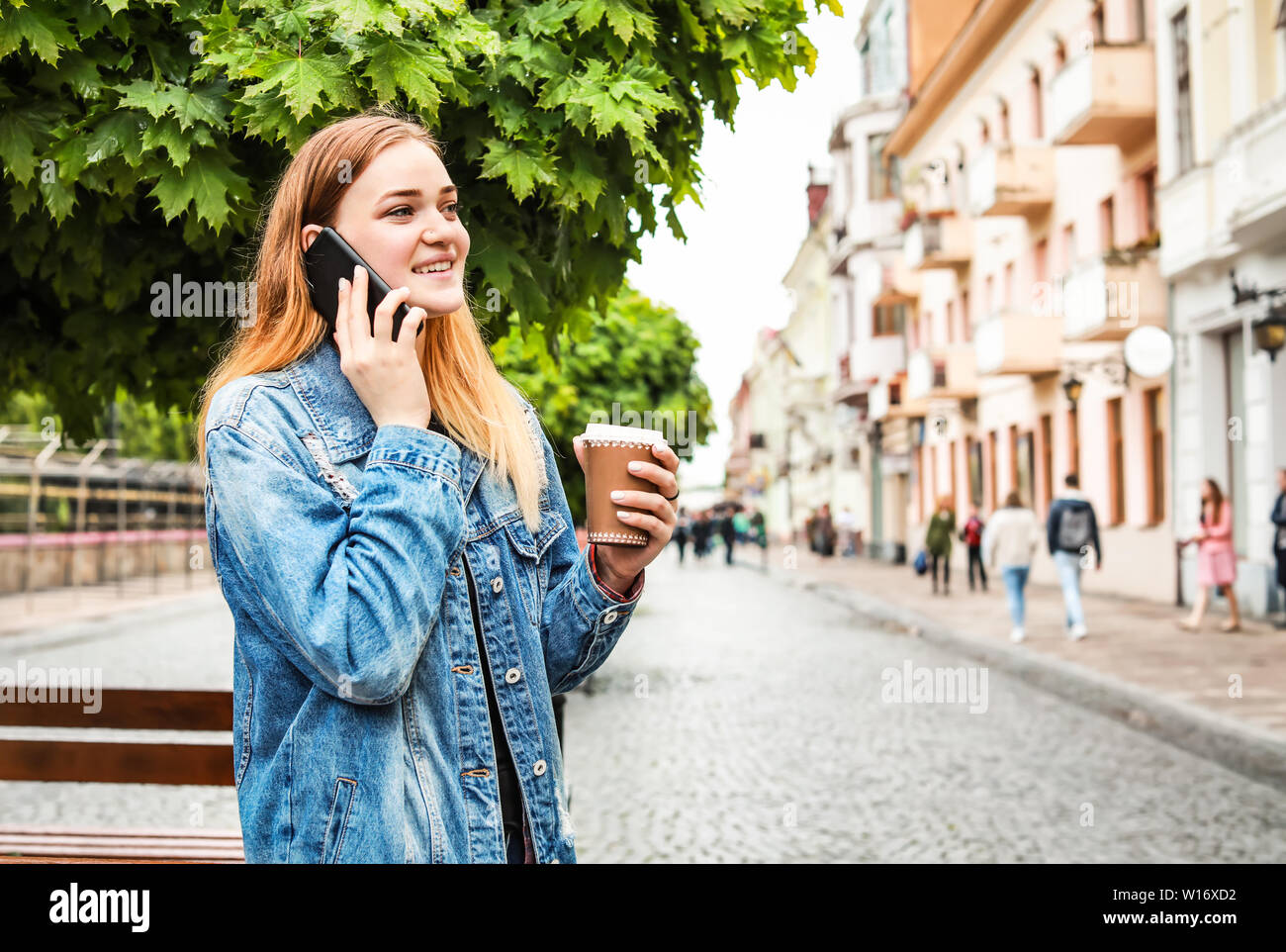 Female tourist talking by phone in beautiful city Stock Photo - Alamy