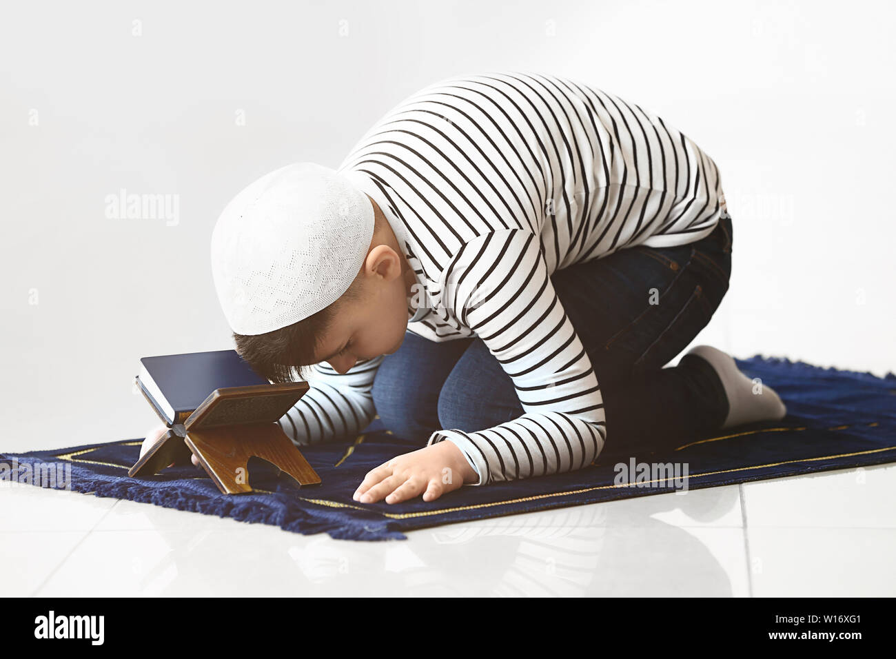 Little Muslim boy praying indoors Stock Photo - Alamy