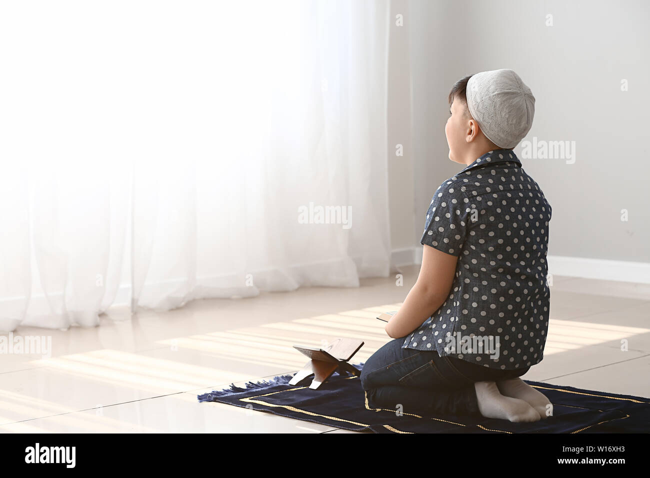 Little Muslim boy praying indoors Stock Photo - Alamy