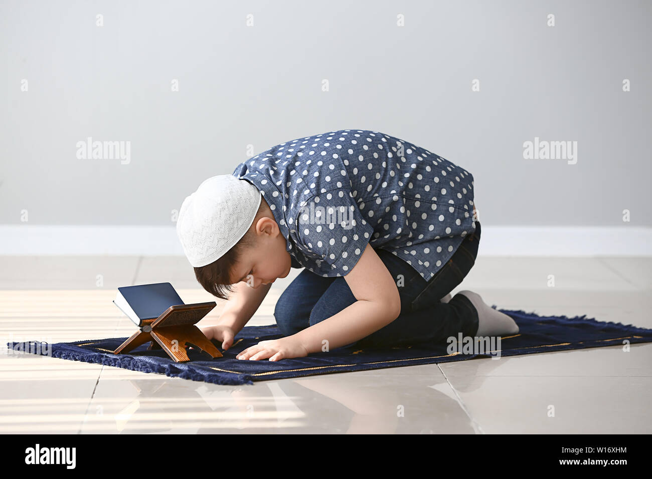 Little Muslim boy praying indoors Stock Photo - Alamy
