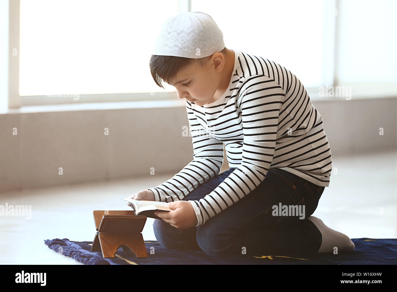 Little Muslim boy praying indoors Stock Photo - Alamy