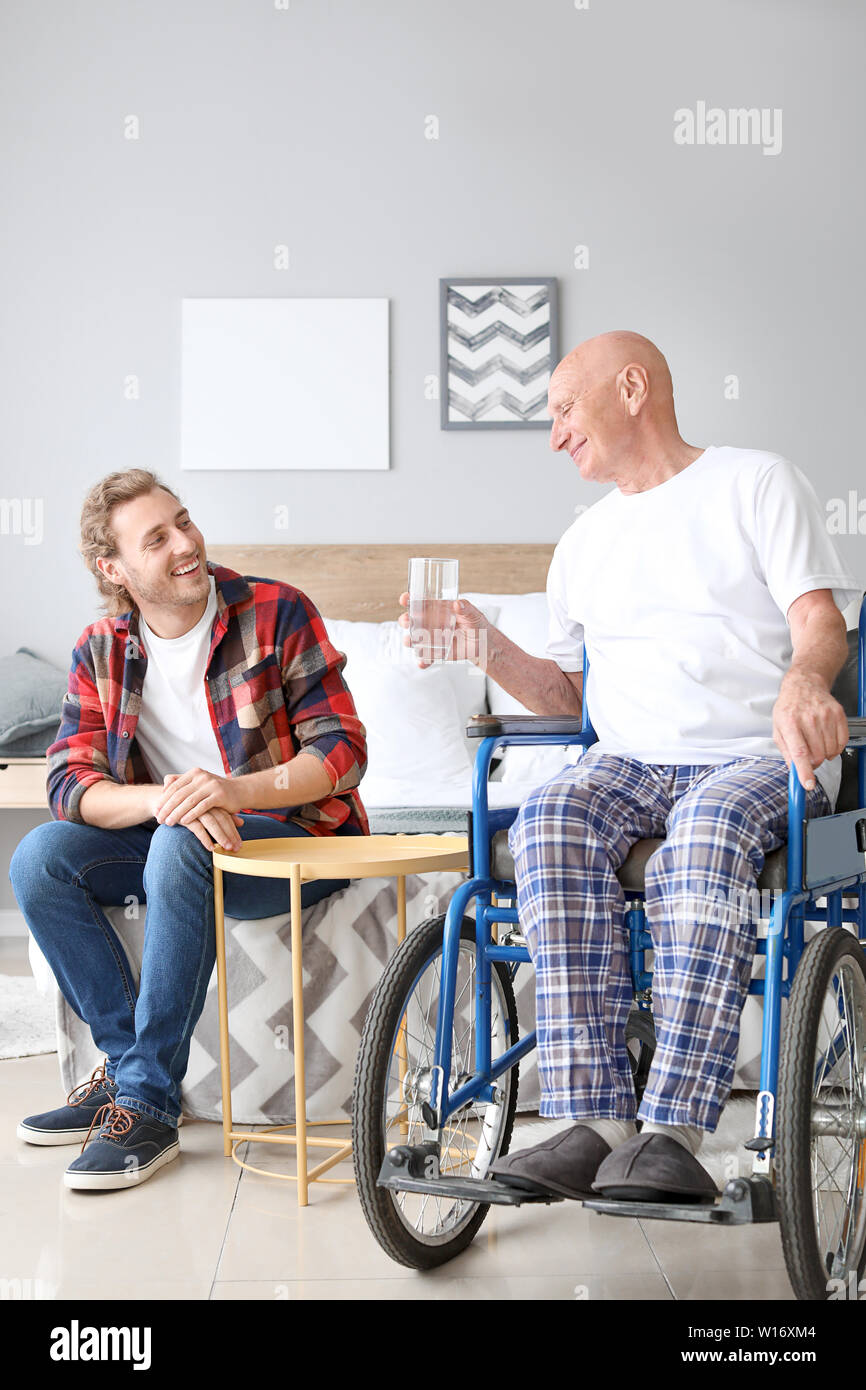 Young man visiting his father in nursing home Stock Photo - Alamy