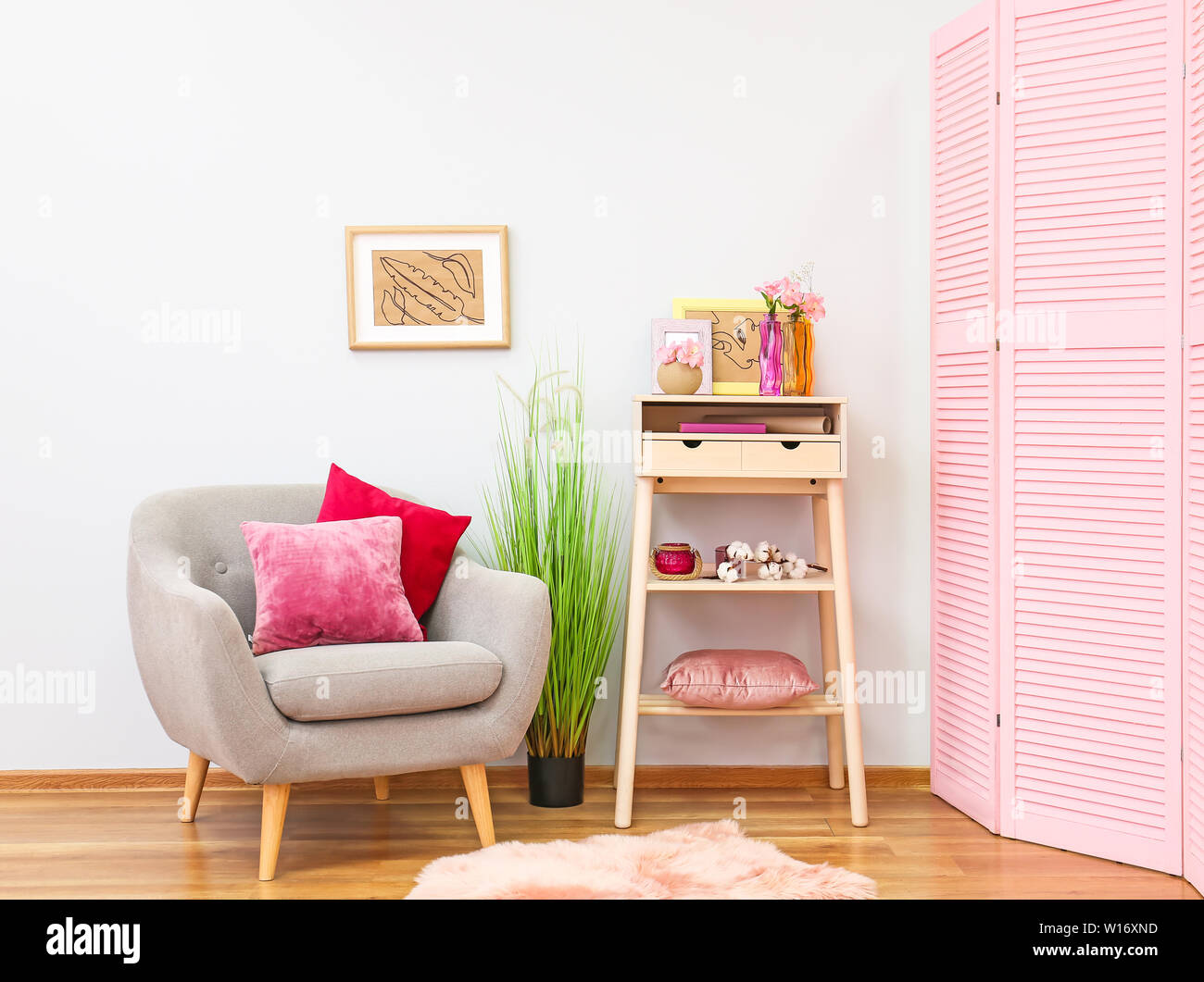 Interior of modern room with armchair, table and pillows Stock Photo ...