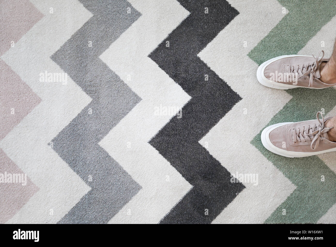 Legs of man standing on soft carpet, top view Stock Photo - Alamy