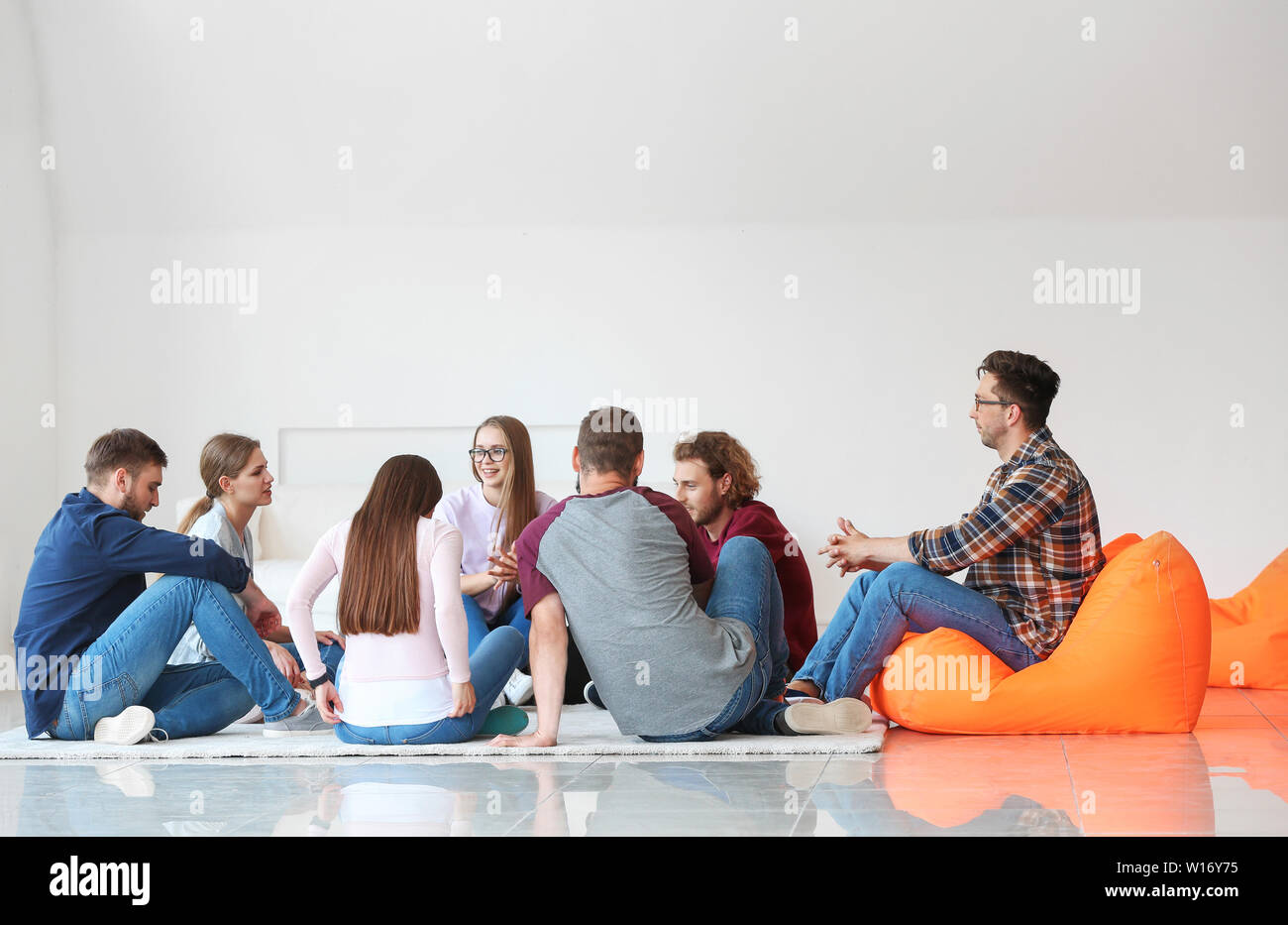Young people with psychologist at group therapy session Stock Photo - Alamy