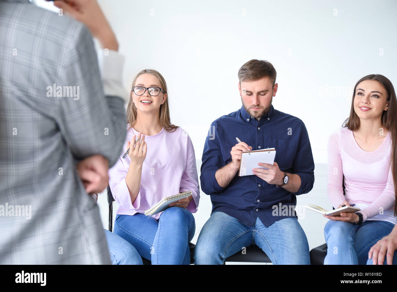 Young people with psychologist at group therapy session Stock Photo - Alamy
