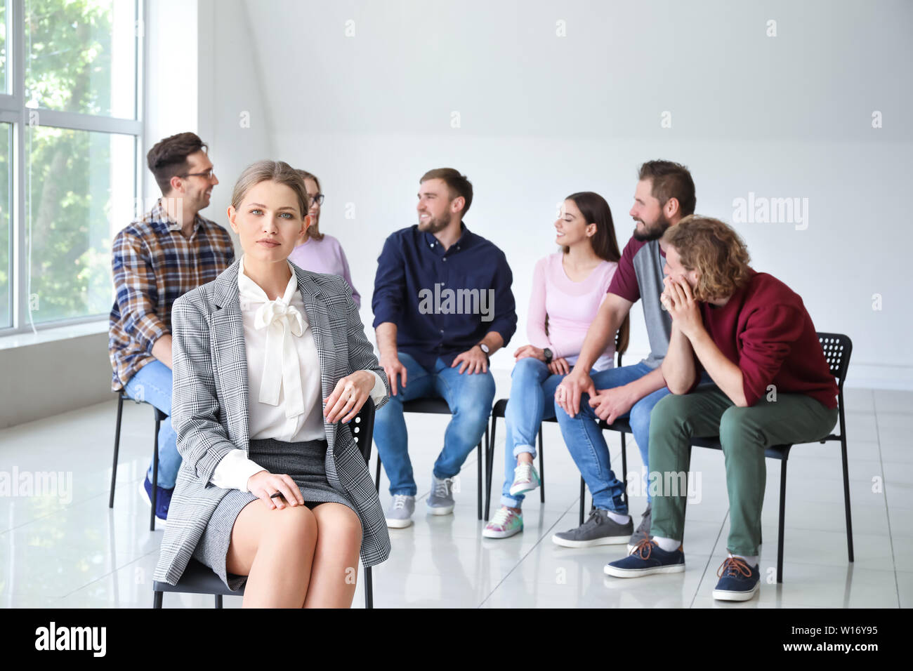 Female psychologist at group therapy session Stock Photo - Alamy
