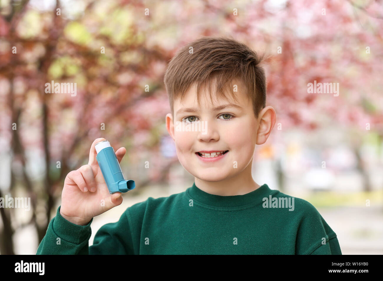 Boy with inhaler outdoors on spring day Stock Photo - Alamy