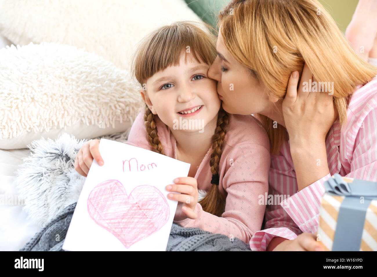 Little girl greeting her mother at home Stock Photo - Alamy