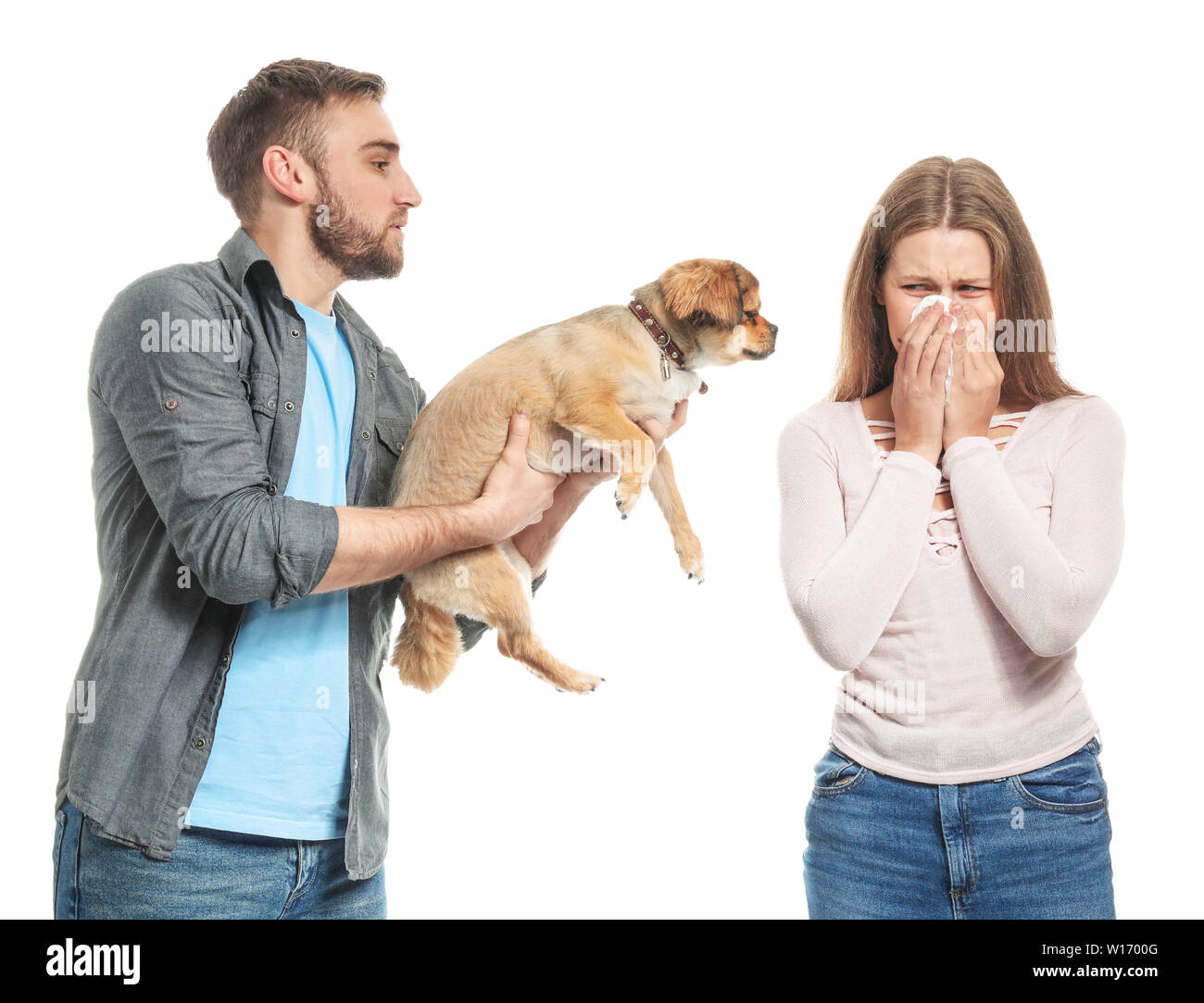 Man with dog and his wife suffering from animal allergy on white ...