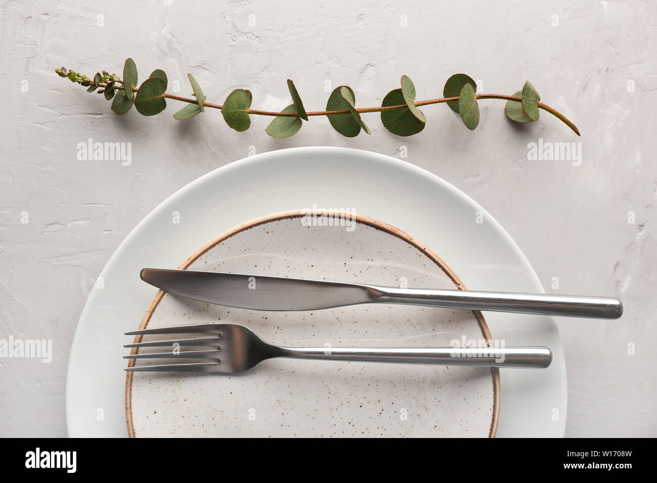 Simple table setting on grunge background Stock Photo - Alamy