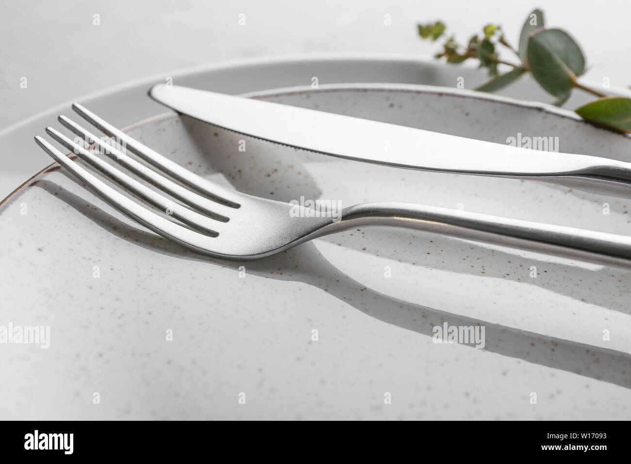 Plates with cutlery on table, closeup Stock Photo - Alamy