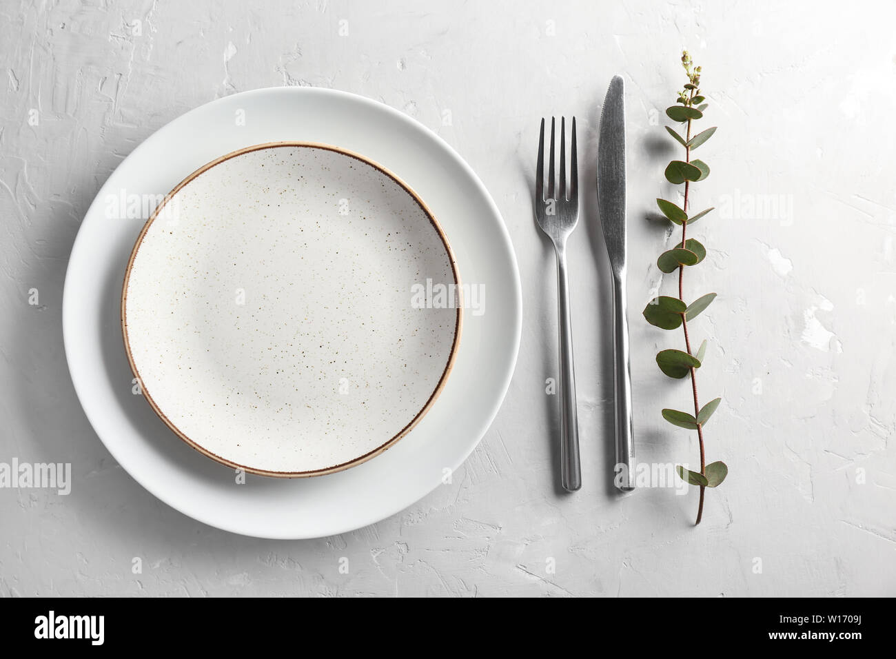Simple table setting on grunge background Stock Photo - Alamy