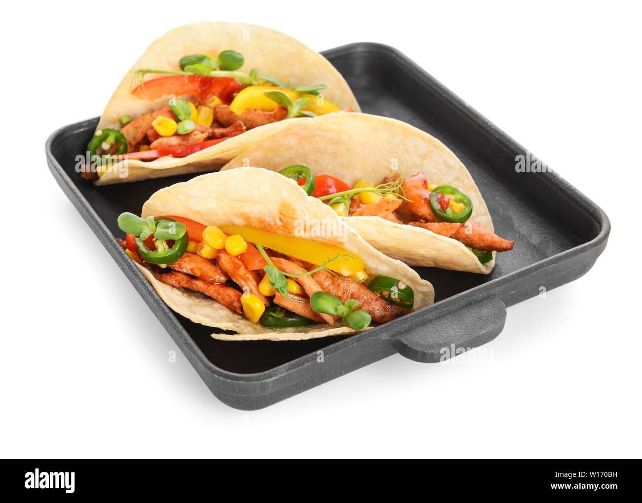 Frying pan with tasty fresh tacos on white background Stock Photo - Alamy