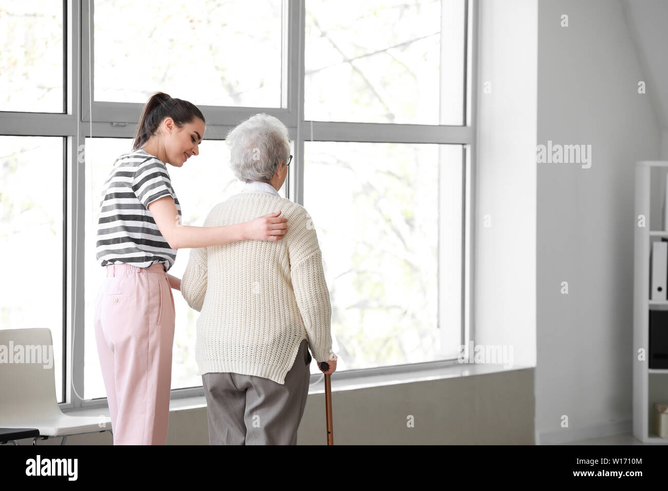 Caregiver with senior woman in nursing home Stock Photo - Alamy