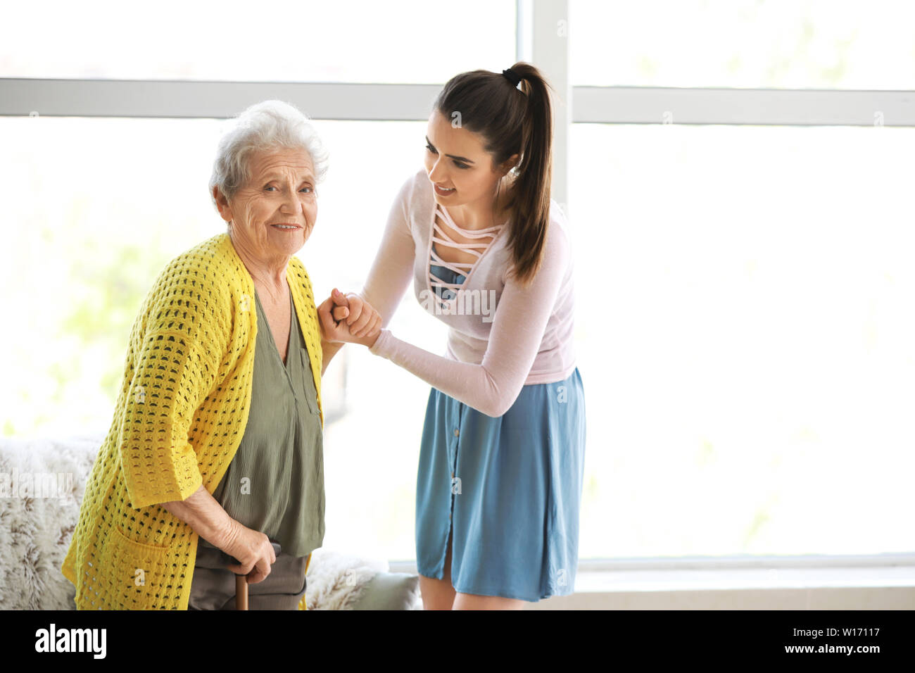 Caregiver with senior woman in nursing home Stock Photo - Alamy