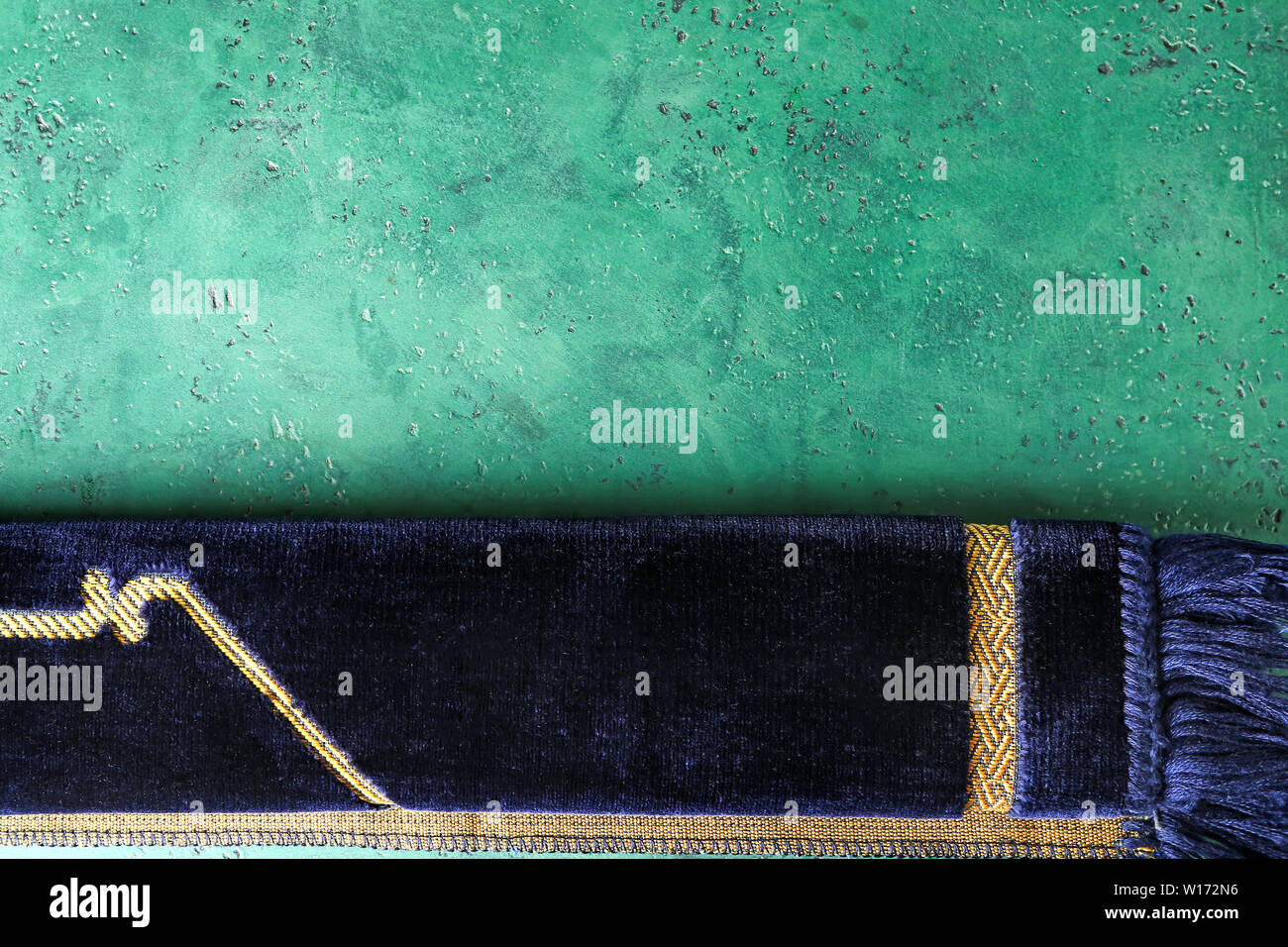 Muslim prayer mat on color background Stock Photo - Alamy